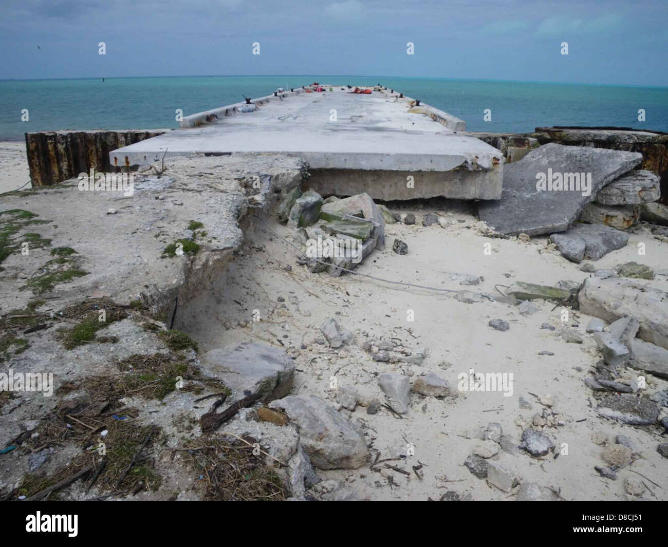 A section of a pier shows significant damage, likely caused by storm or ...
