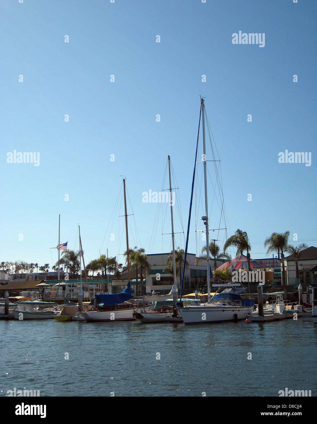 A group of small boats docked along a harbor, tied securely to the ...