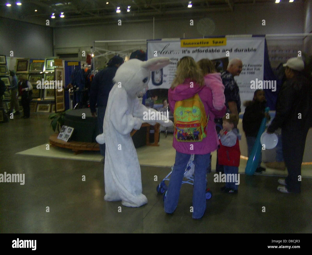 An entertainer dressed as the Easter Bunny engages with a crowd during ...