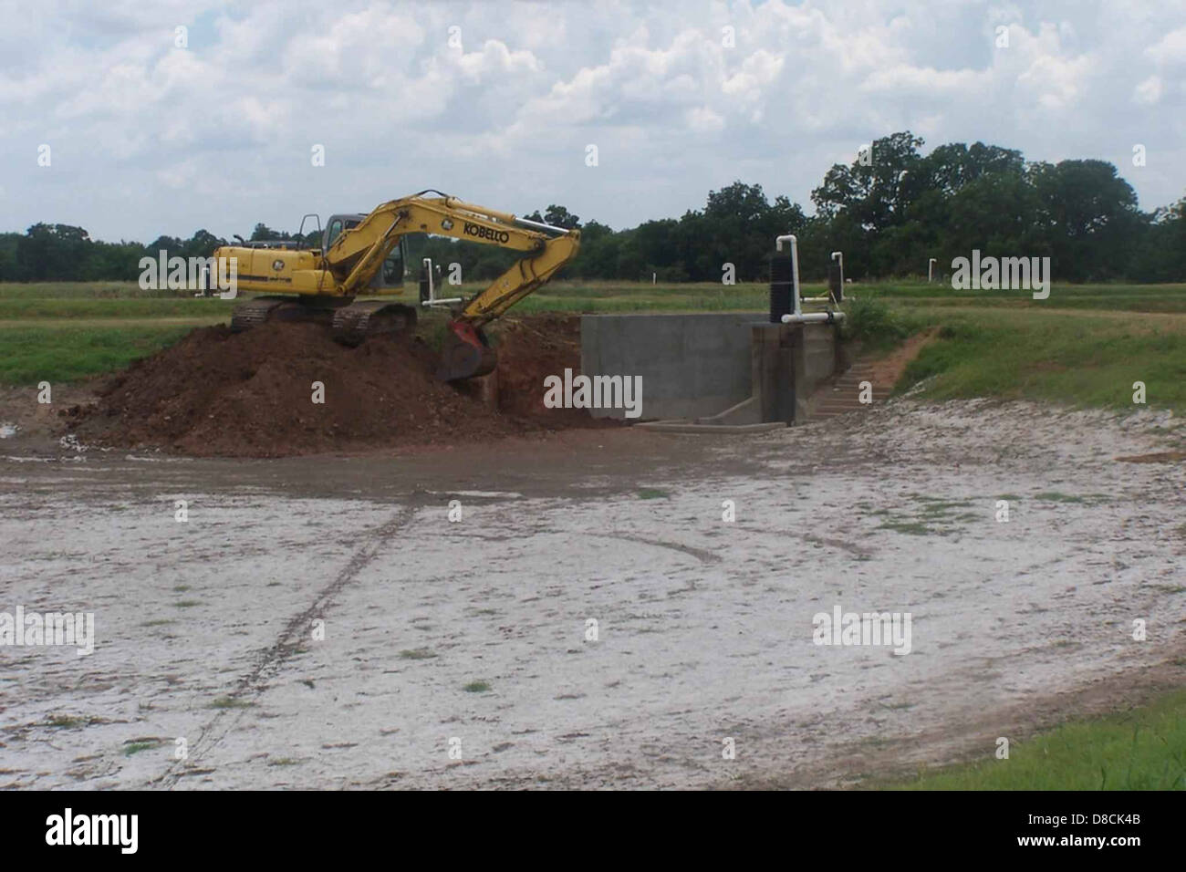 An excavator in action, digging into the earth to move large amounts of ...