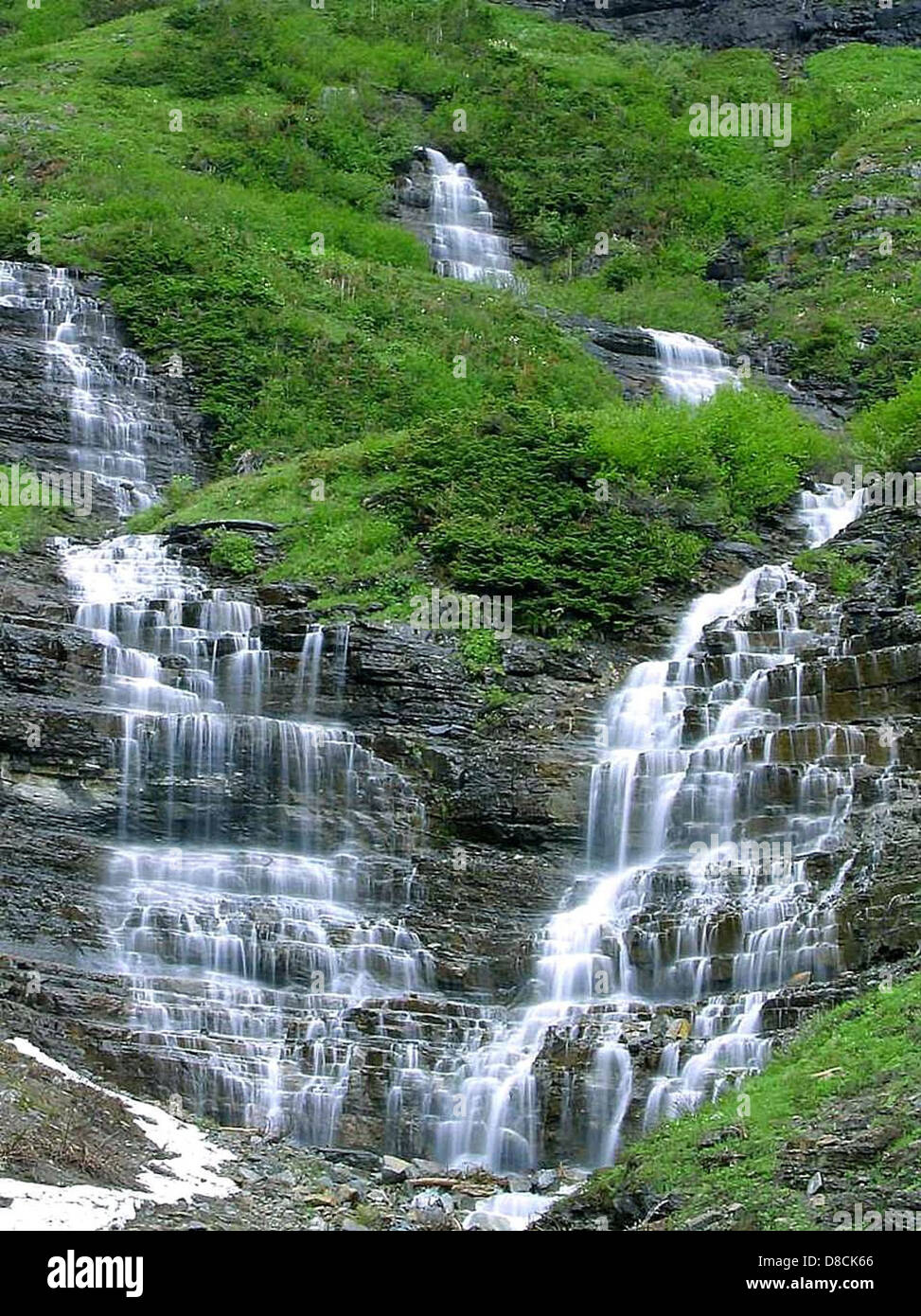 The image captures a waterfall cascading down from a glacier. The ...