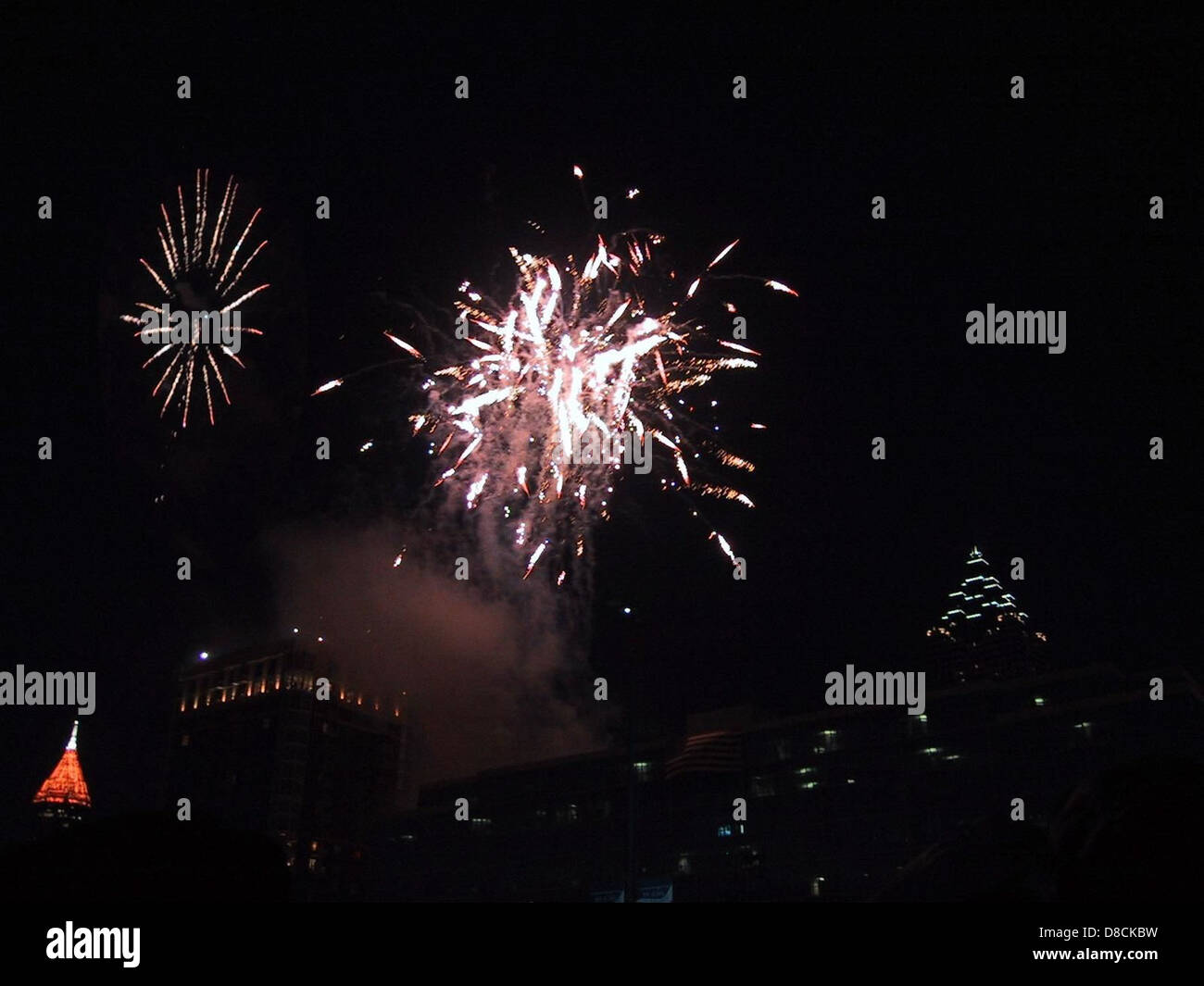 A display of colorful fireworks lighting up the night sky over a city ...