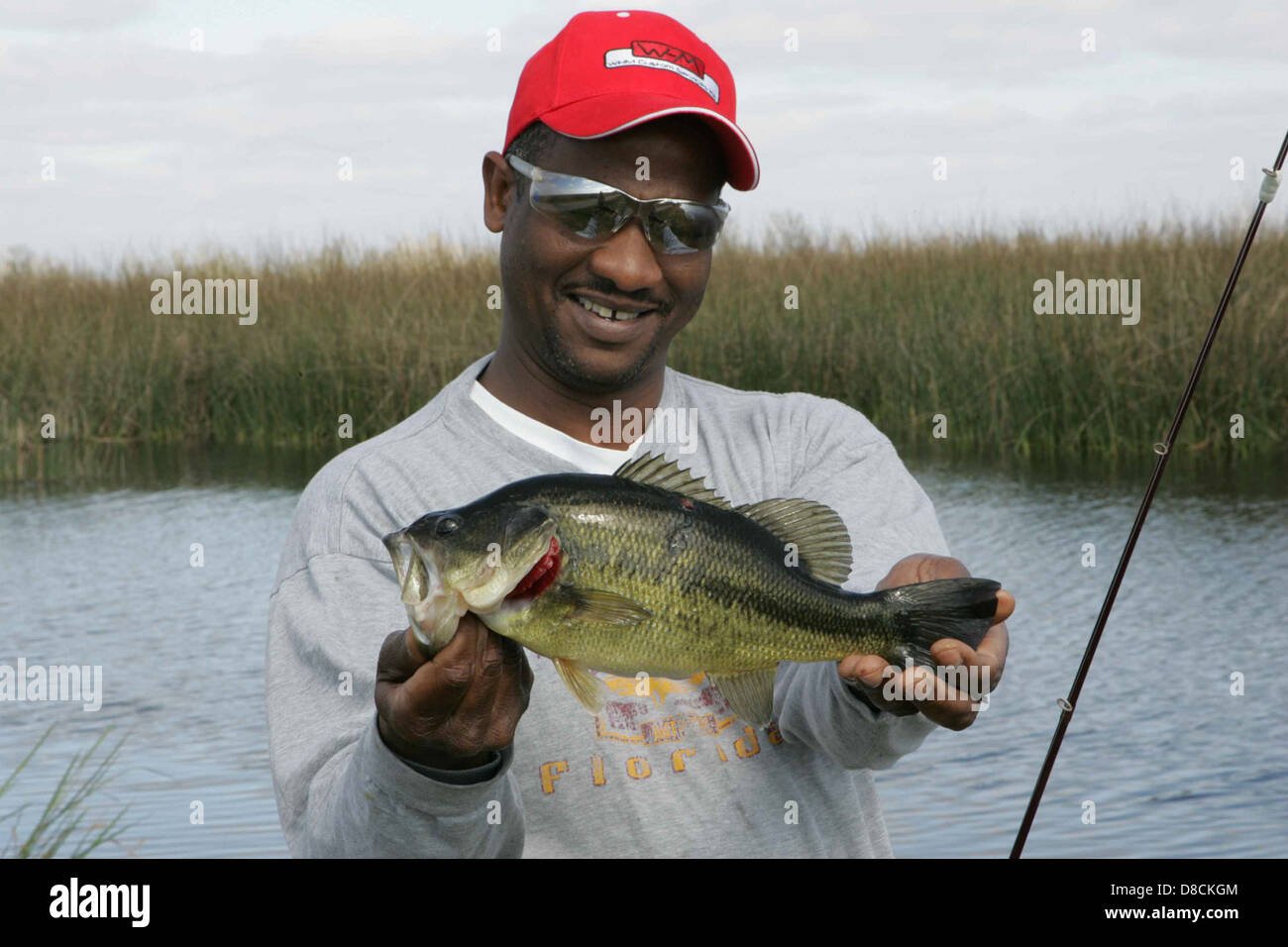 Fisherman proudly shows off his catch Stock Photo - Alamy