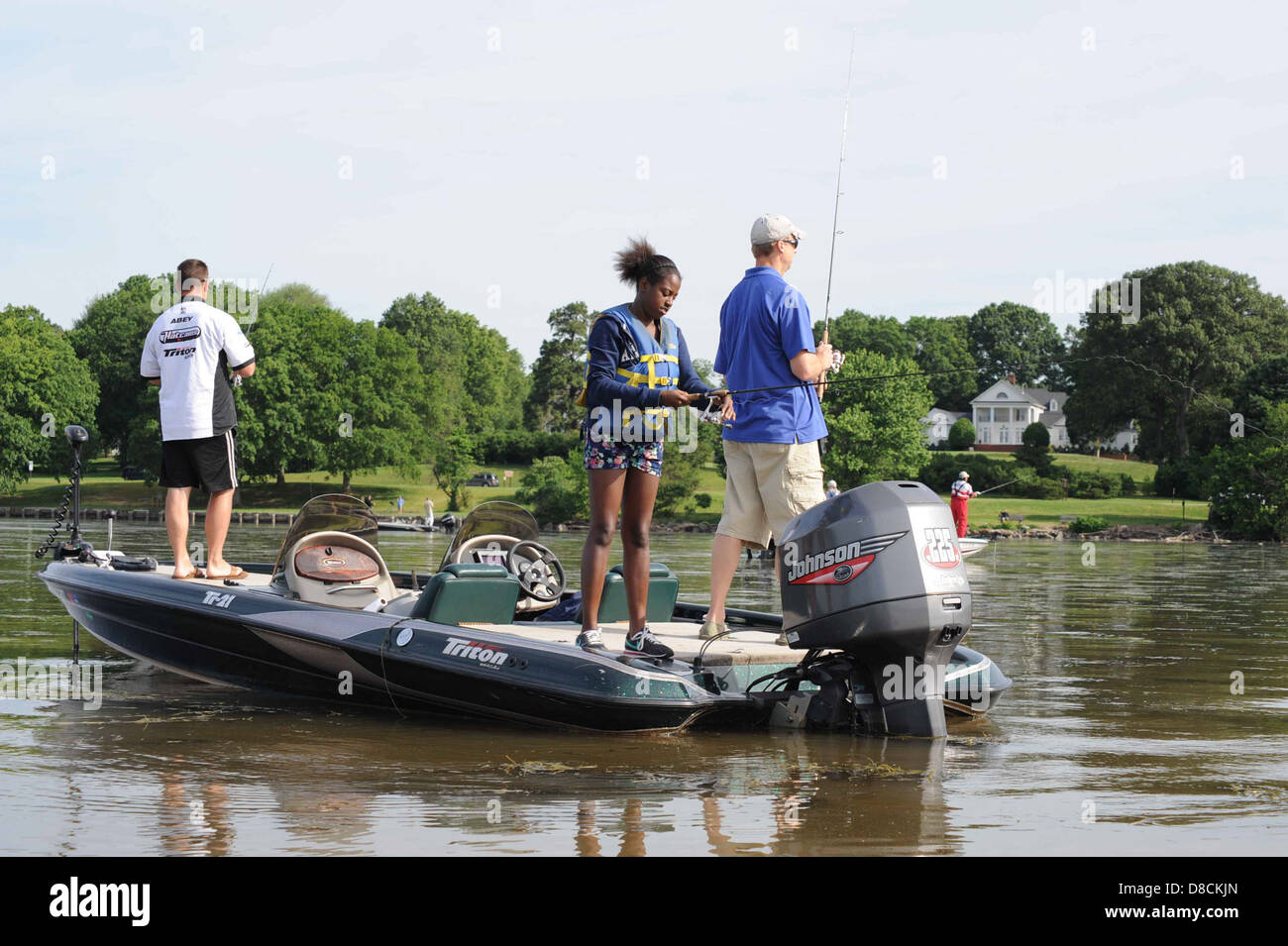 A person fishing from a speed boat on the open water. The boat is ...