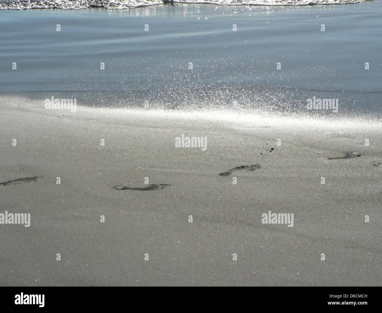 This photo shows footprints in the sand, likely left by a person ...