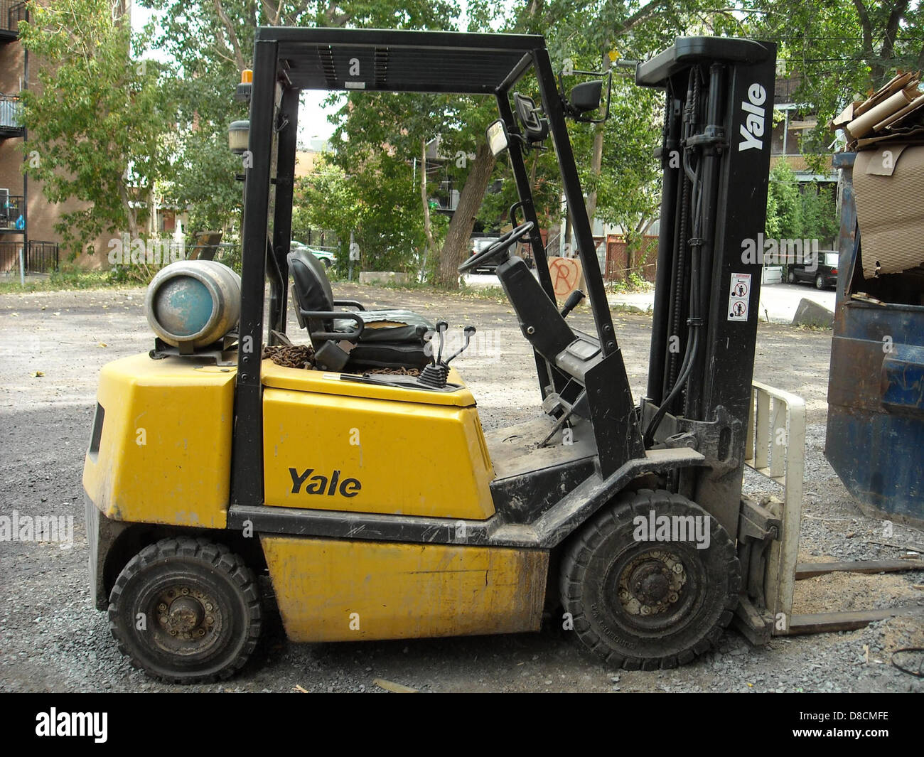 A forklift vehicle in action, lifting a large load in a warehouse or ...