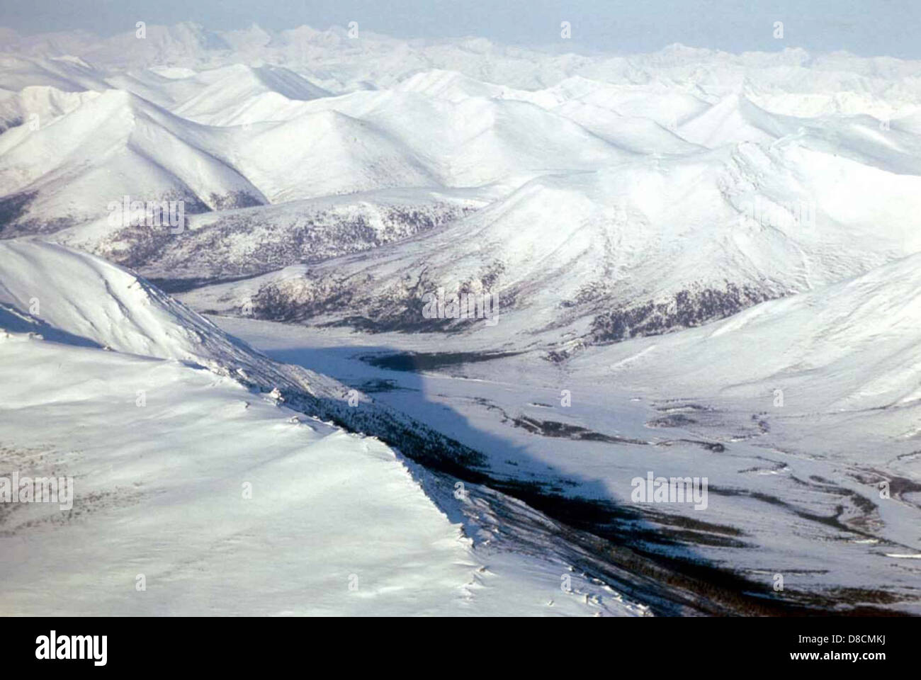 A panoramic view of high mountain peaks covered in frost, showcasing ...