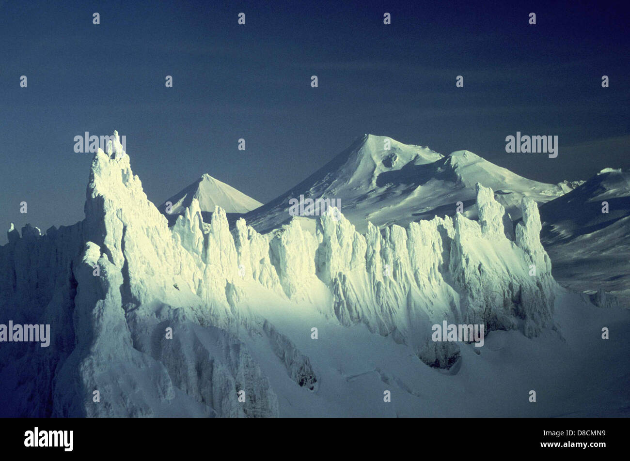 The frozen peaks of Aghlean Pinnacles, covered with snow, create a ...