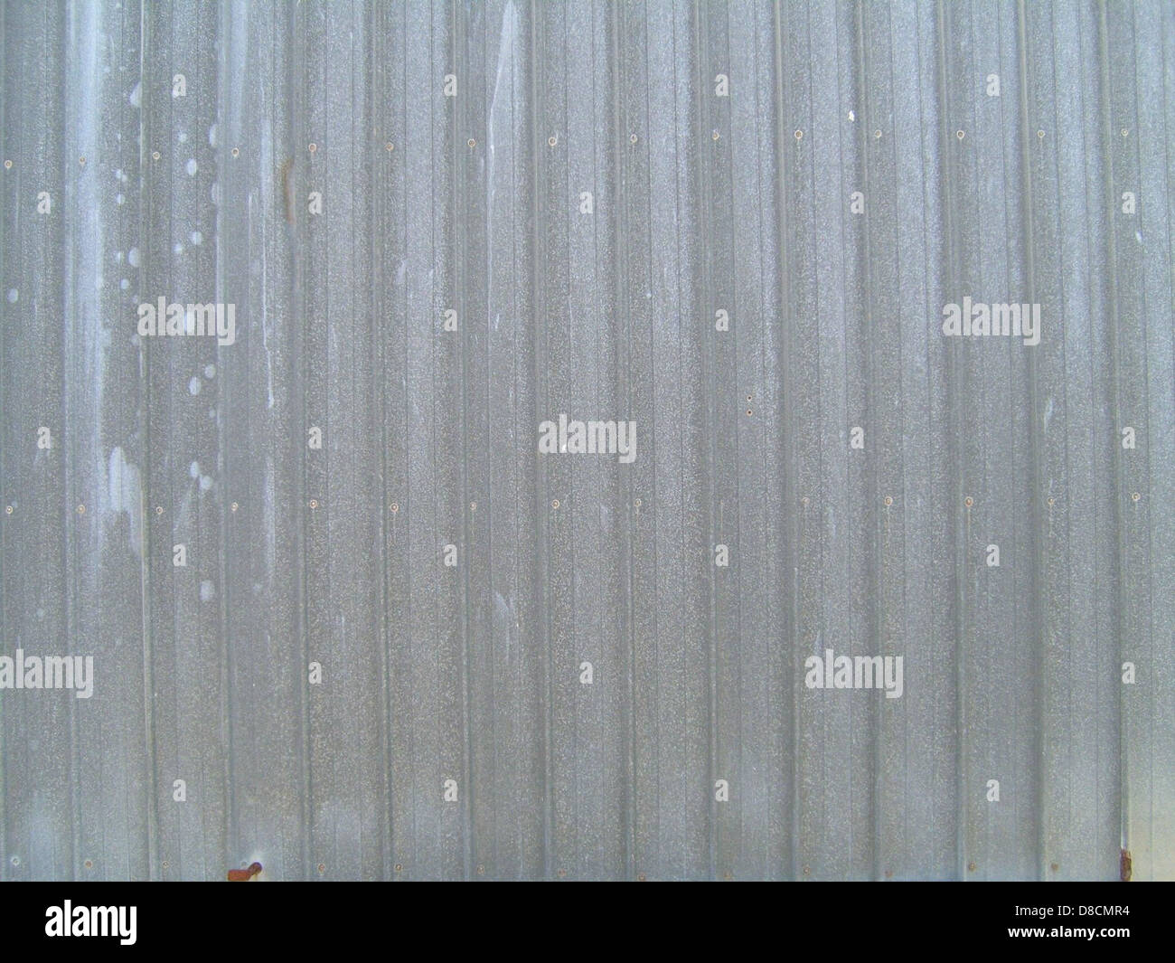 A close-up of a galvanized metal wall, showcasing its textured surface ...