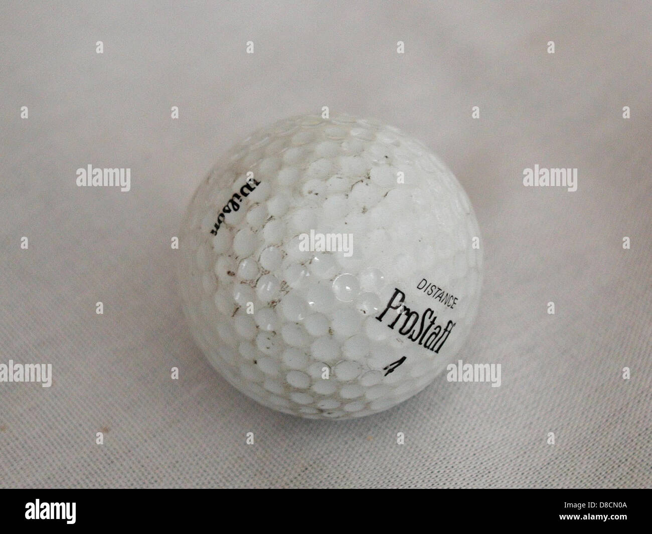 This image features a close-up shot of a golf ball, highlighting its ...