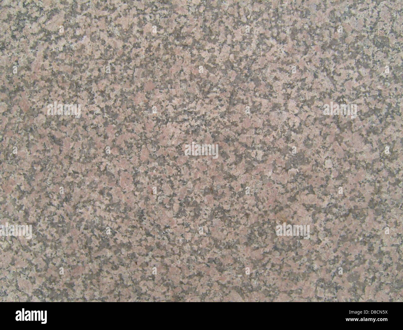 A detailed photograph of a granite surface, showcasing the natural ...