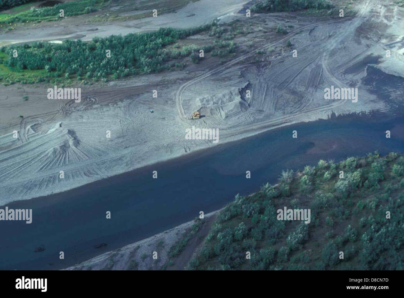 An aerial view of a gravel extraction site, showing machinery and ...
