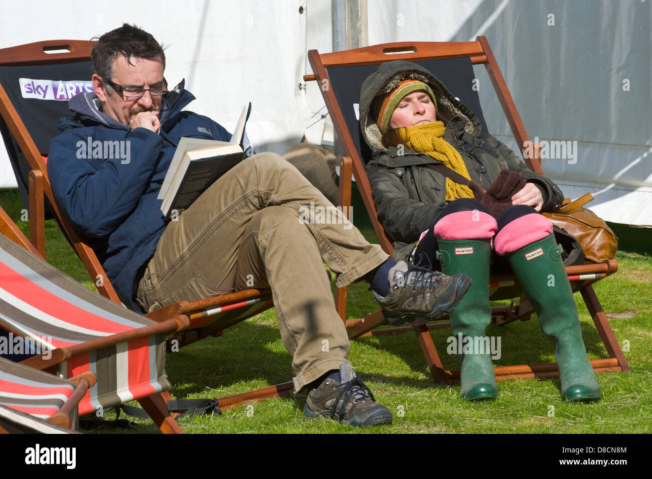 Visitors reading & sleeping sitting in the sun sat in deckchairs but ...