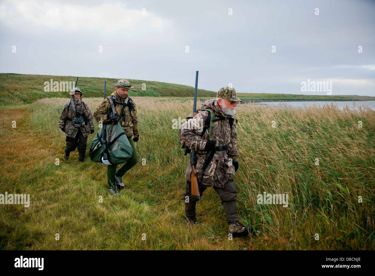 A group of hunters on a lake, preparing for a duck hunting excursion ...