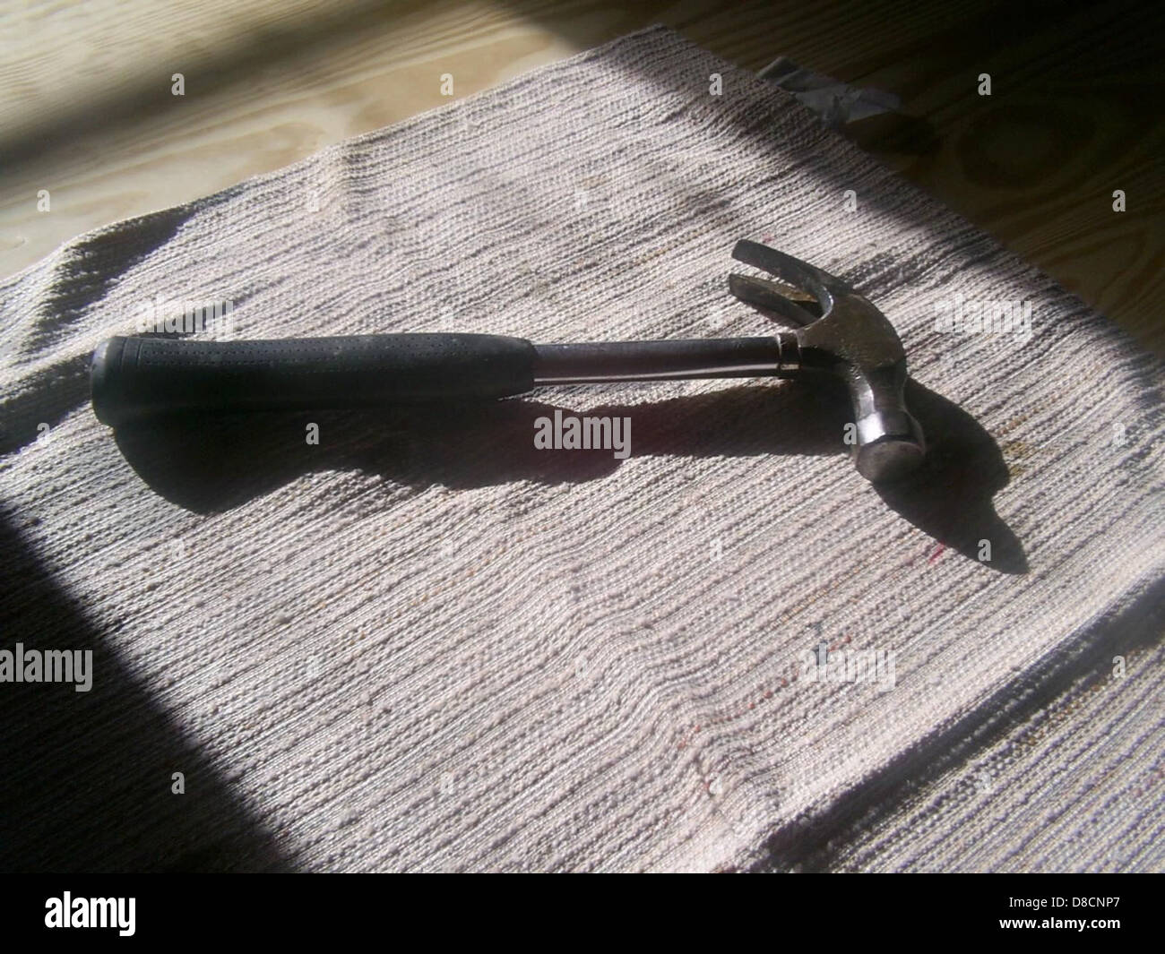 A close-up of a hammer, a basic hand tool used for driving nails ...