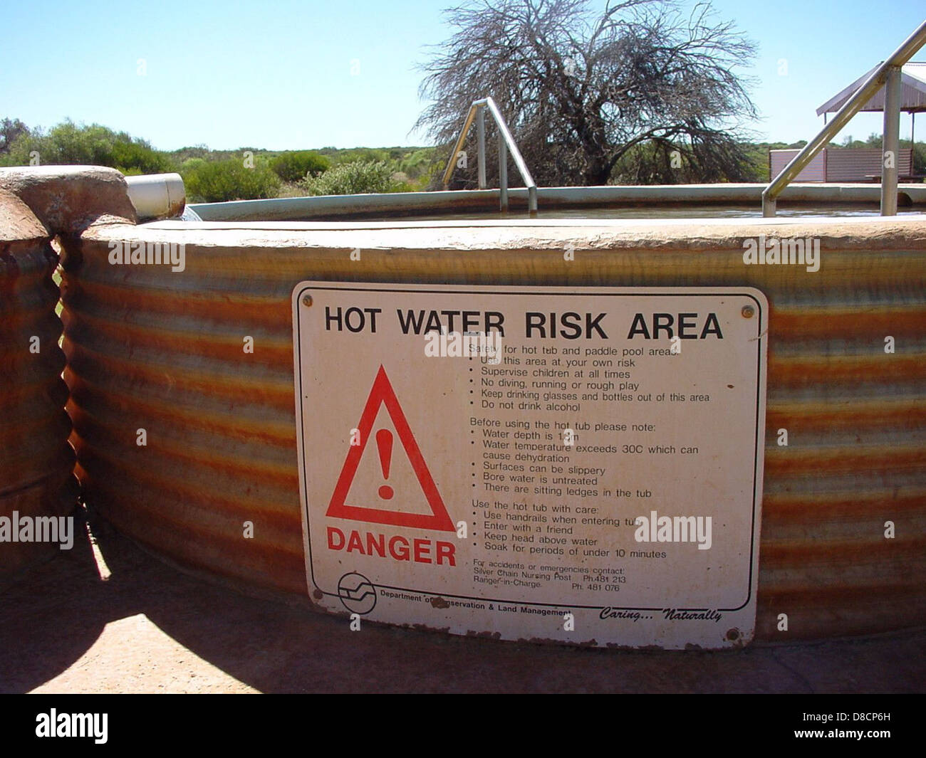 A warning sign indicating a hot water pool, cautioning visitors about ...