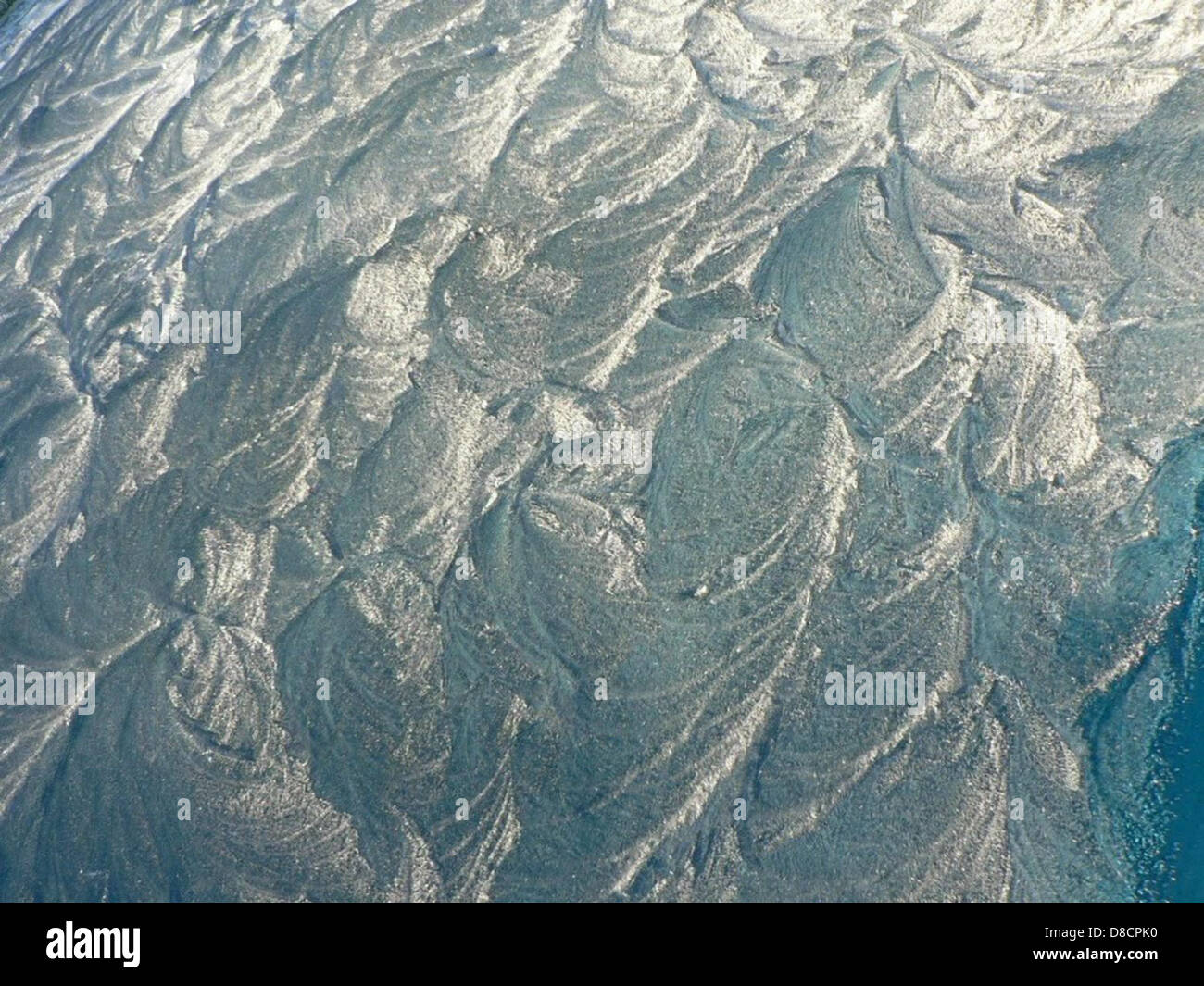 This close-up image features intricate frost patterns that have formed ...