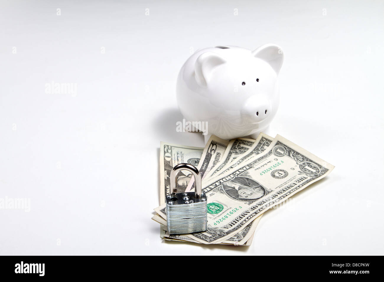 White piggy bank with American dollar bills and a padlock Stock Photo ...