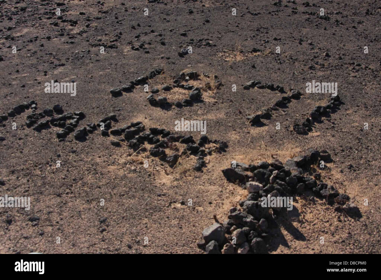 A solemn image of a grave site, marked with a headstone. The grave is ...