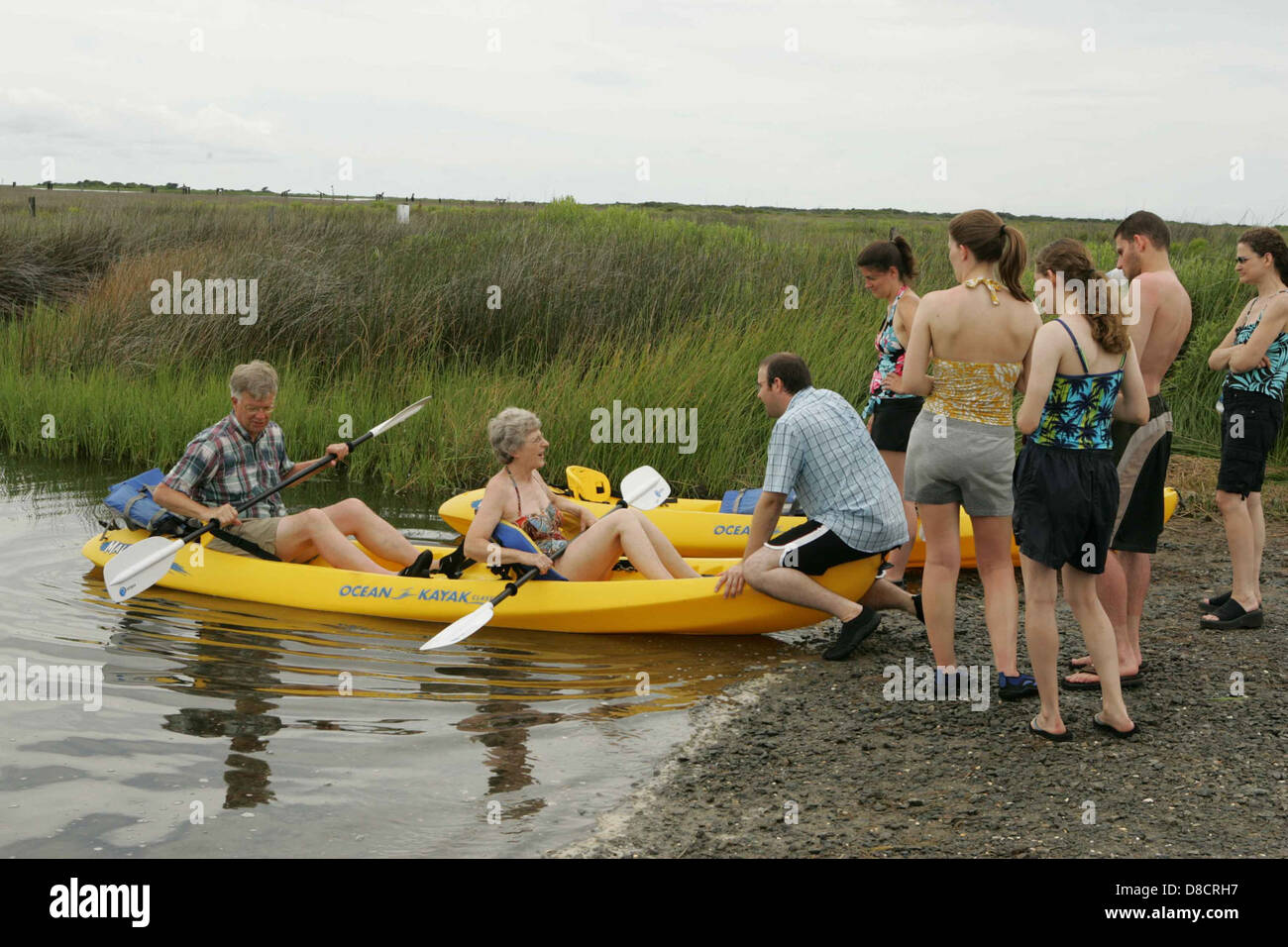 This image shows kayakers navigating a body of water, likely a river ...