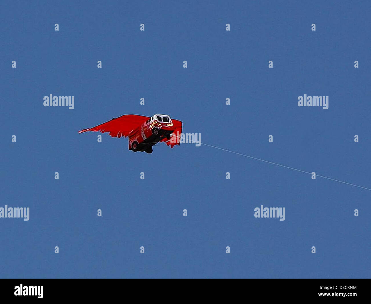 A person flying a colorful kite on a clear day. The kite soars high ...