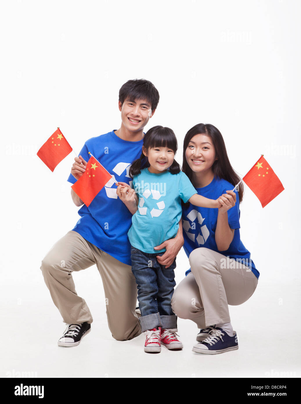 Family Portrait, one child with parents, waving Chinese flags, studio ...