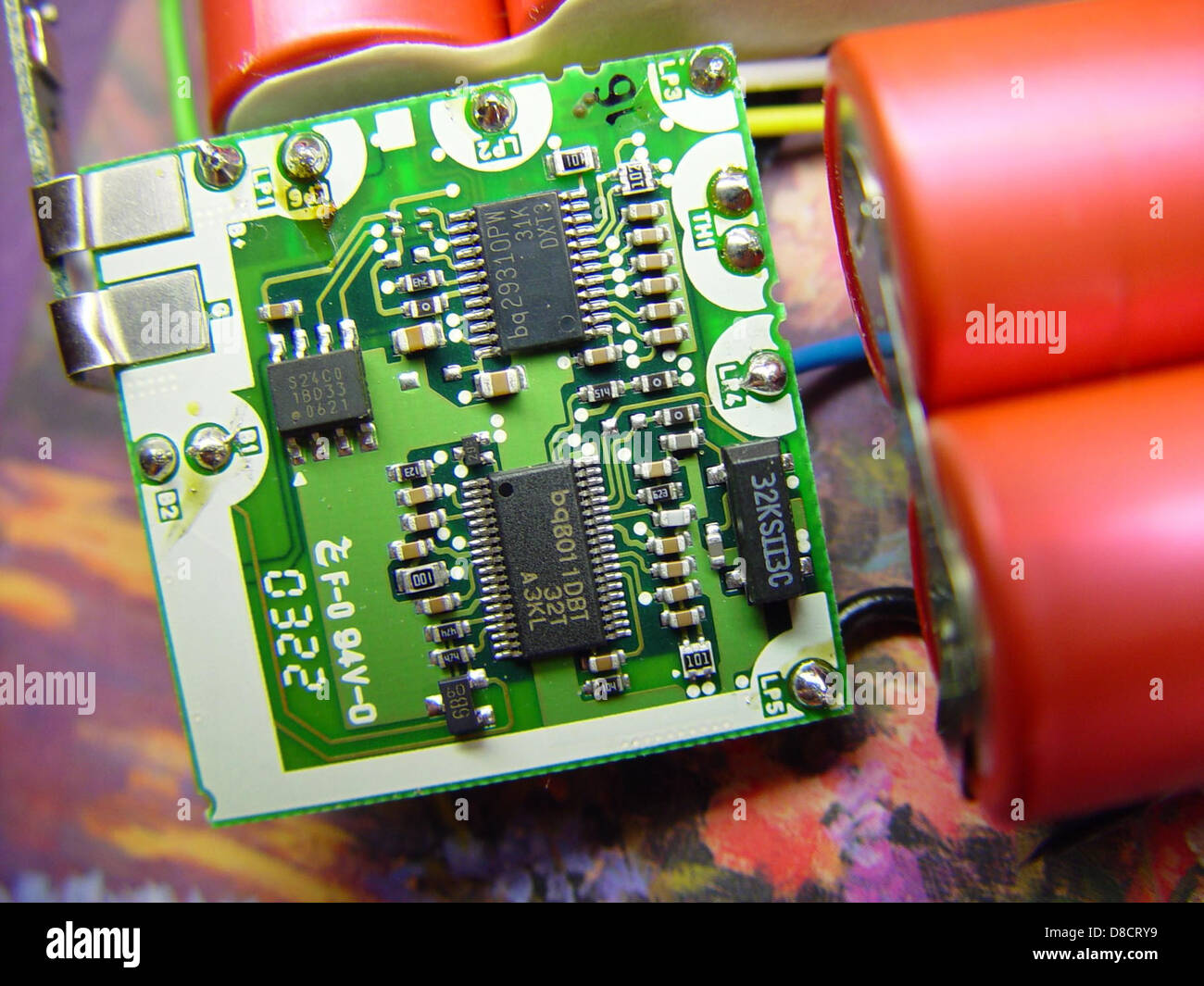 A close-up view of a laptop battery charger circuit board, showing the ...