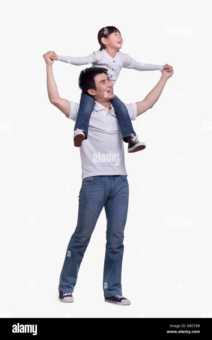 Father carrying daughter on his shoulders, studio shot Stock Photo - Alamy