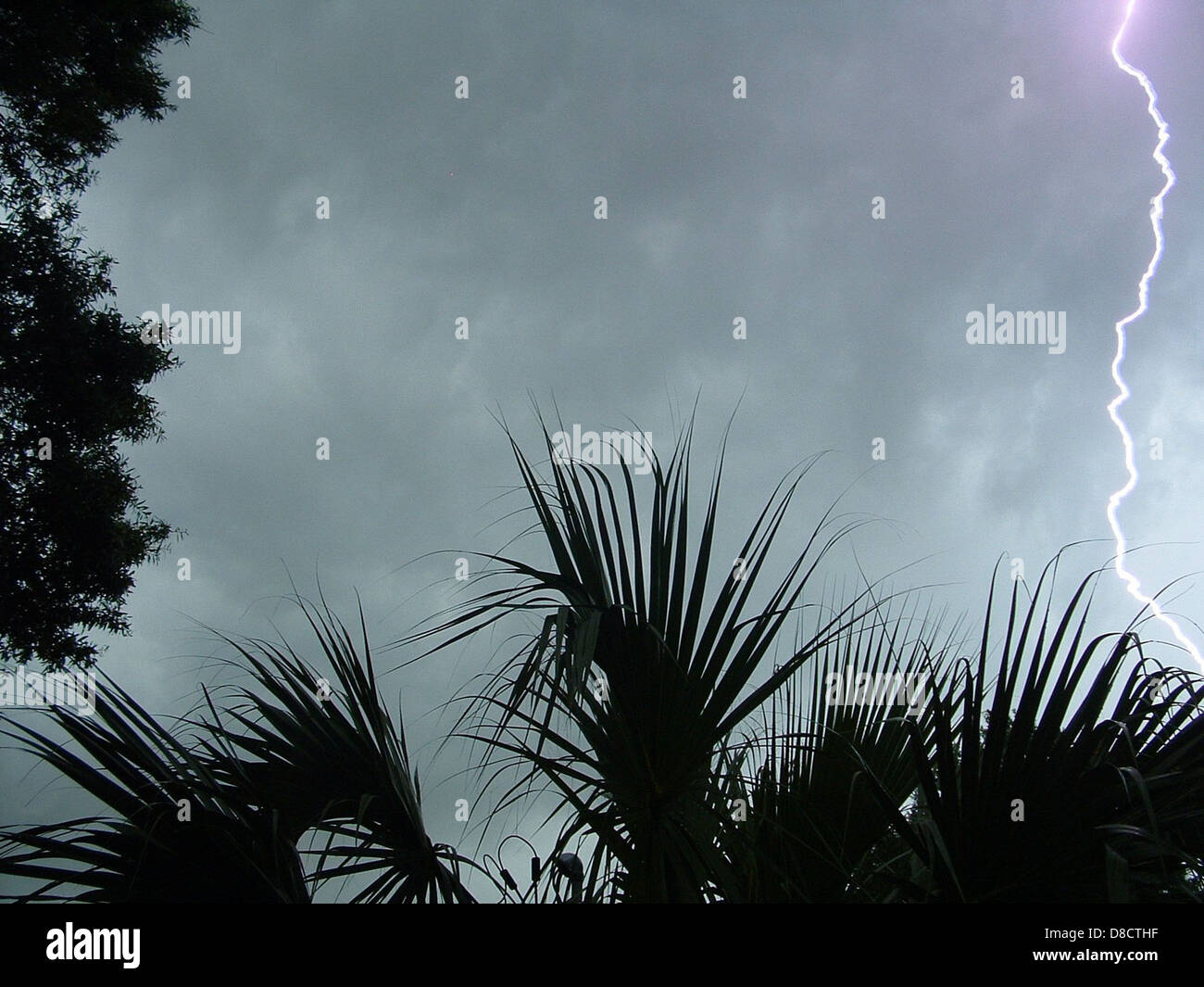 A dramatic image of a lightning strike illuminating the sky during a ...