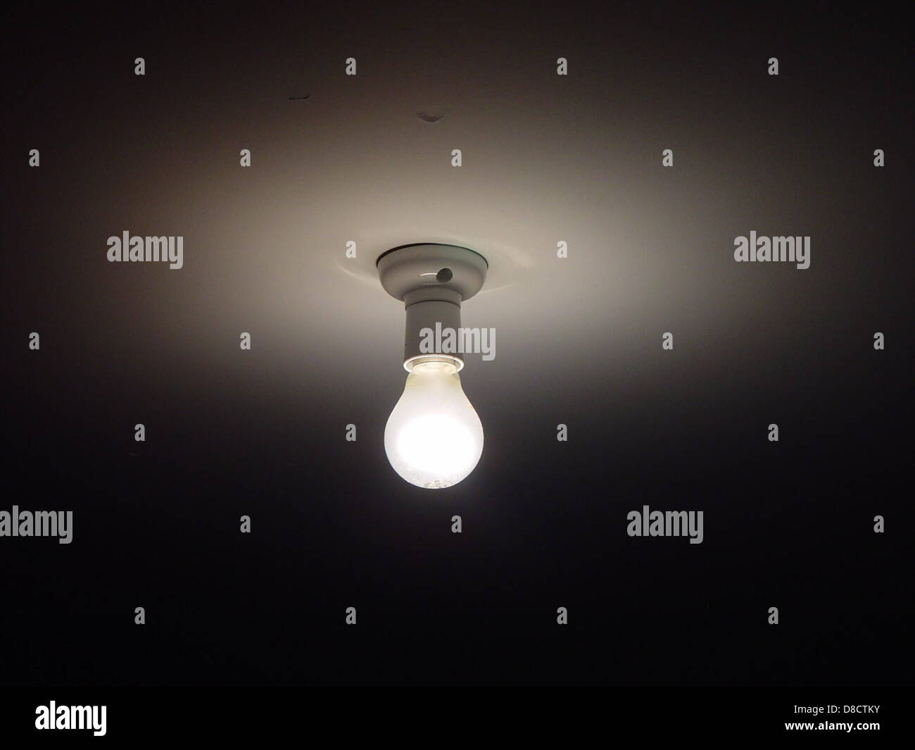 A classic light bulb, commonly used in electrical fixtures, shown in a ...