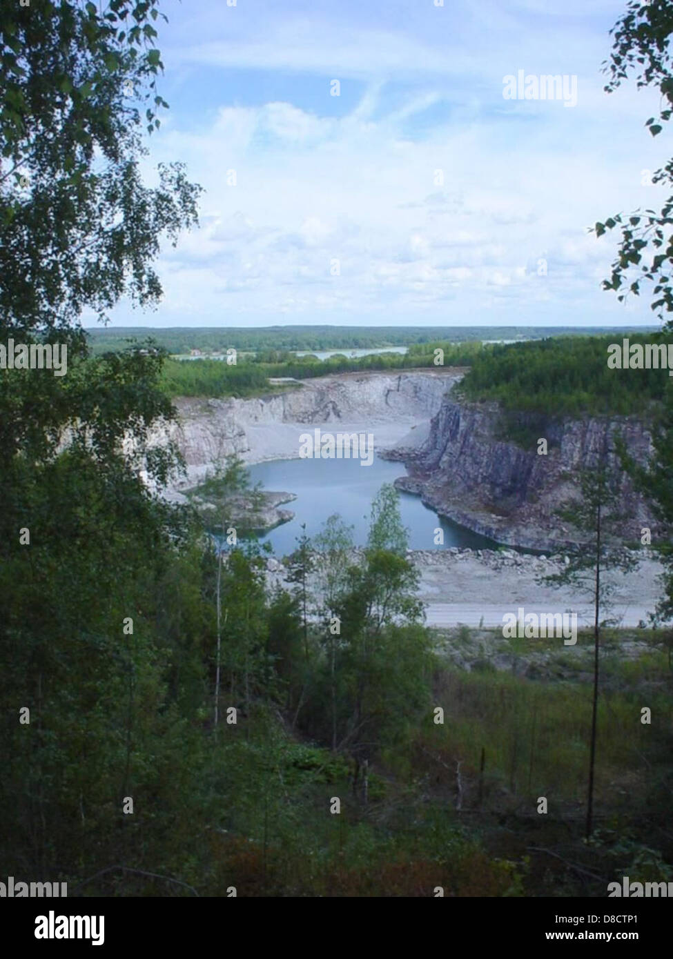 A wide shot of a limestone quarry, showcasing the extraction of ...