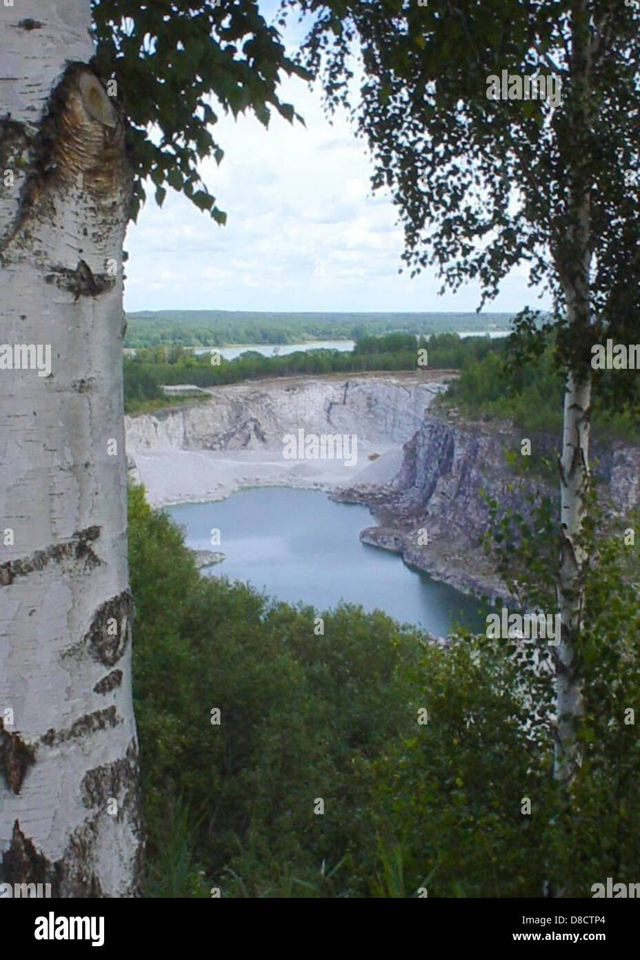 A wide view of a limestone quarry, showing the layers of rock and heavy ...
