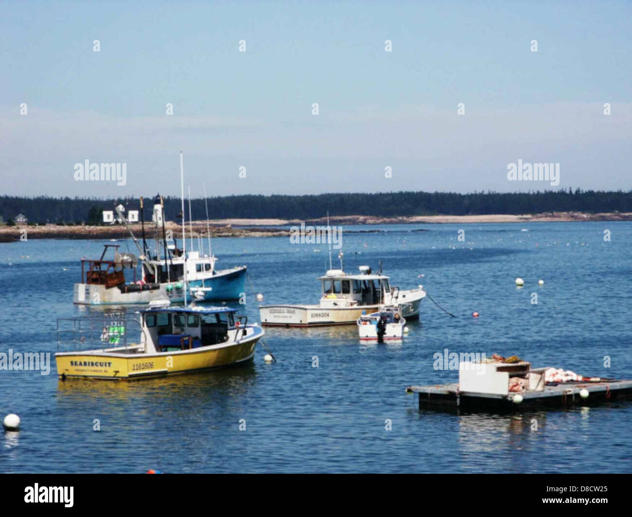 Lobster boats docked in a harbor, ready for a day's work. The boats are ...
