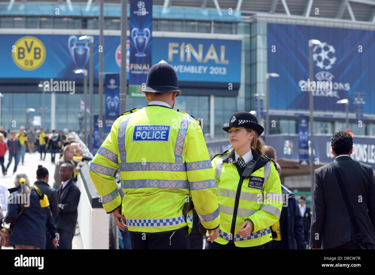 Police officers stand in front of the Wembley stadium in London ...