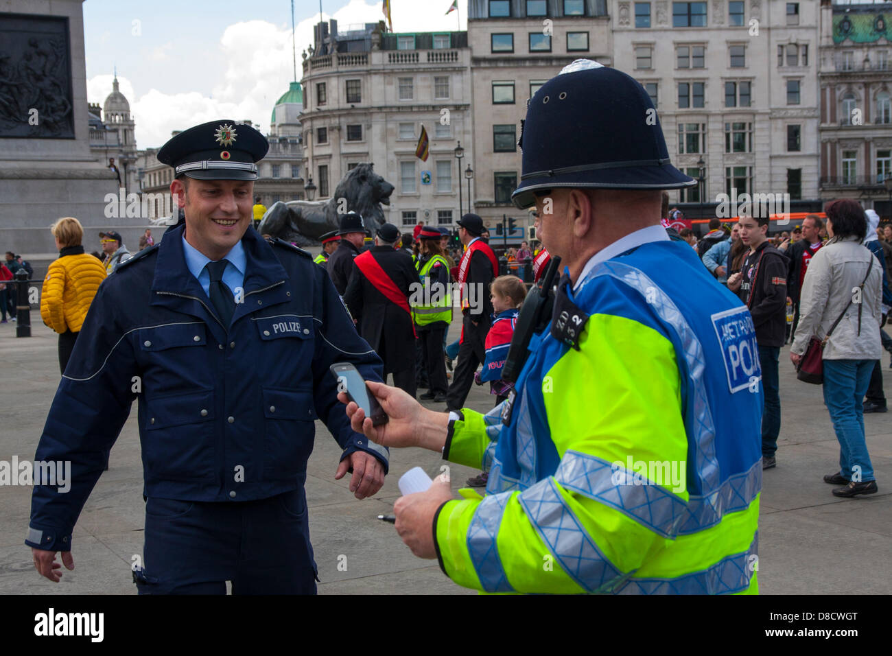 London, UK. 25th May 2013. A British bobby and his German counterpart ...