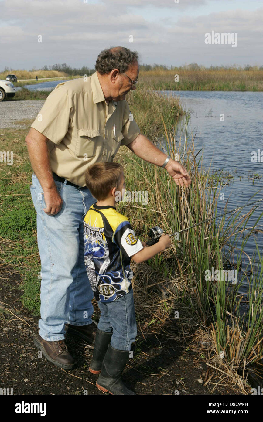 Man shows boy how to fish Stock Photo - Alamy