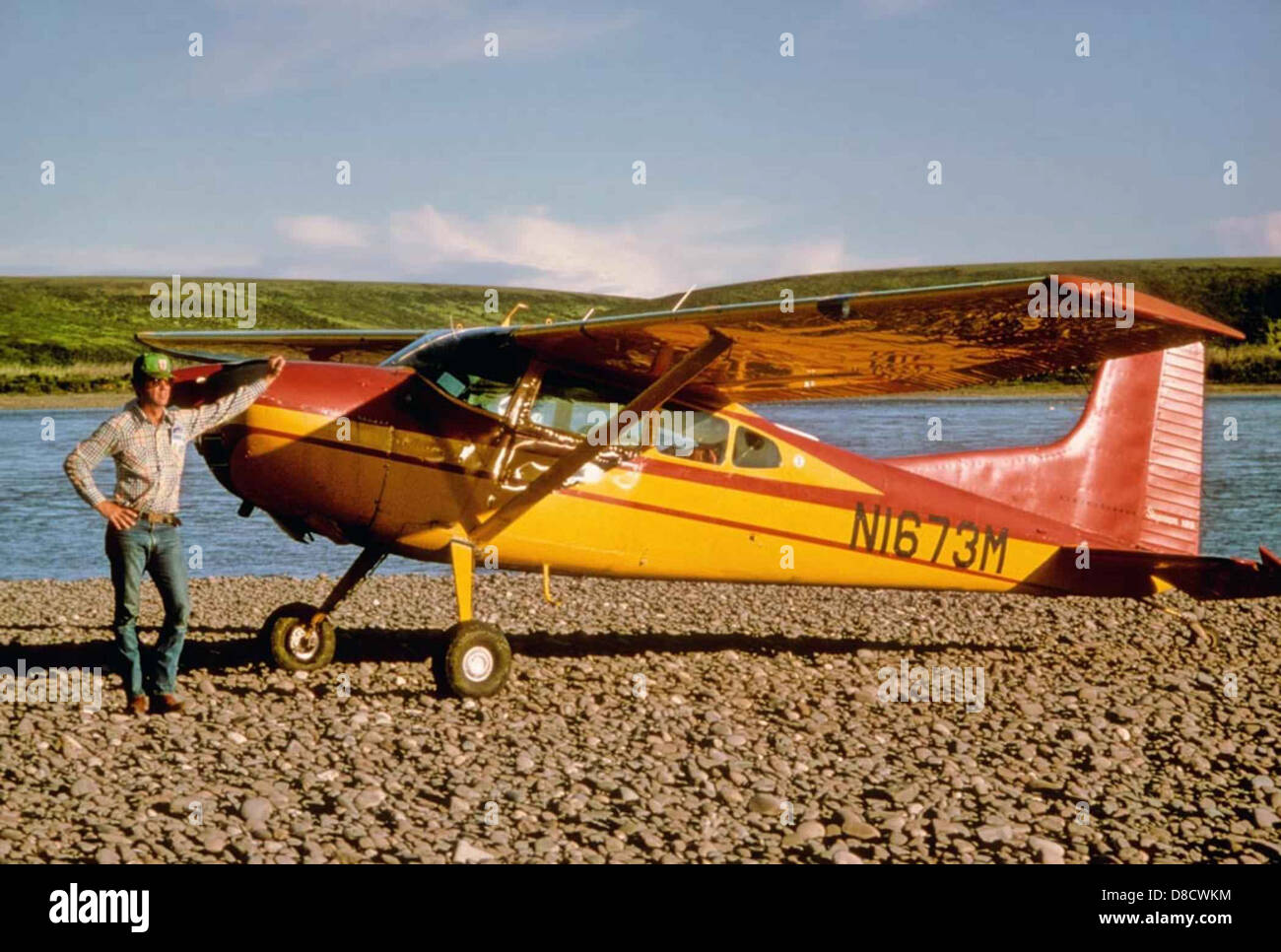 Man standing next to a small old airplane Stock Photo - Alamy