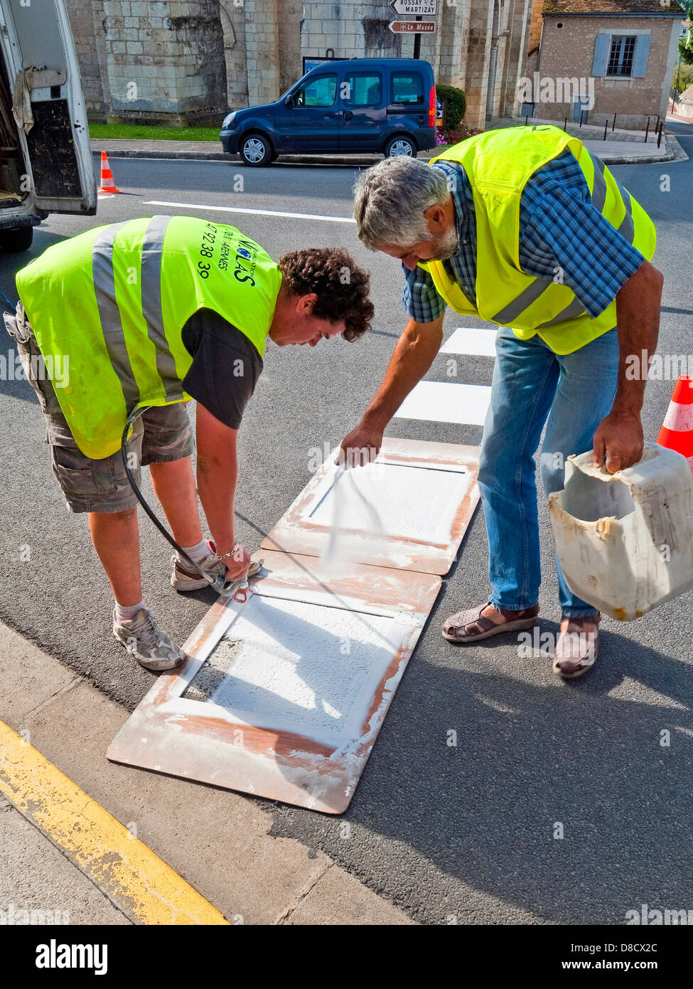 Council workers spraying white line on road - France Stock Photo - Alamy
