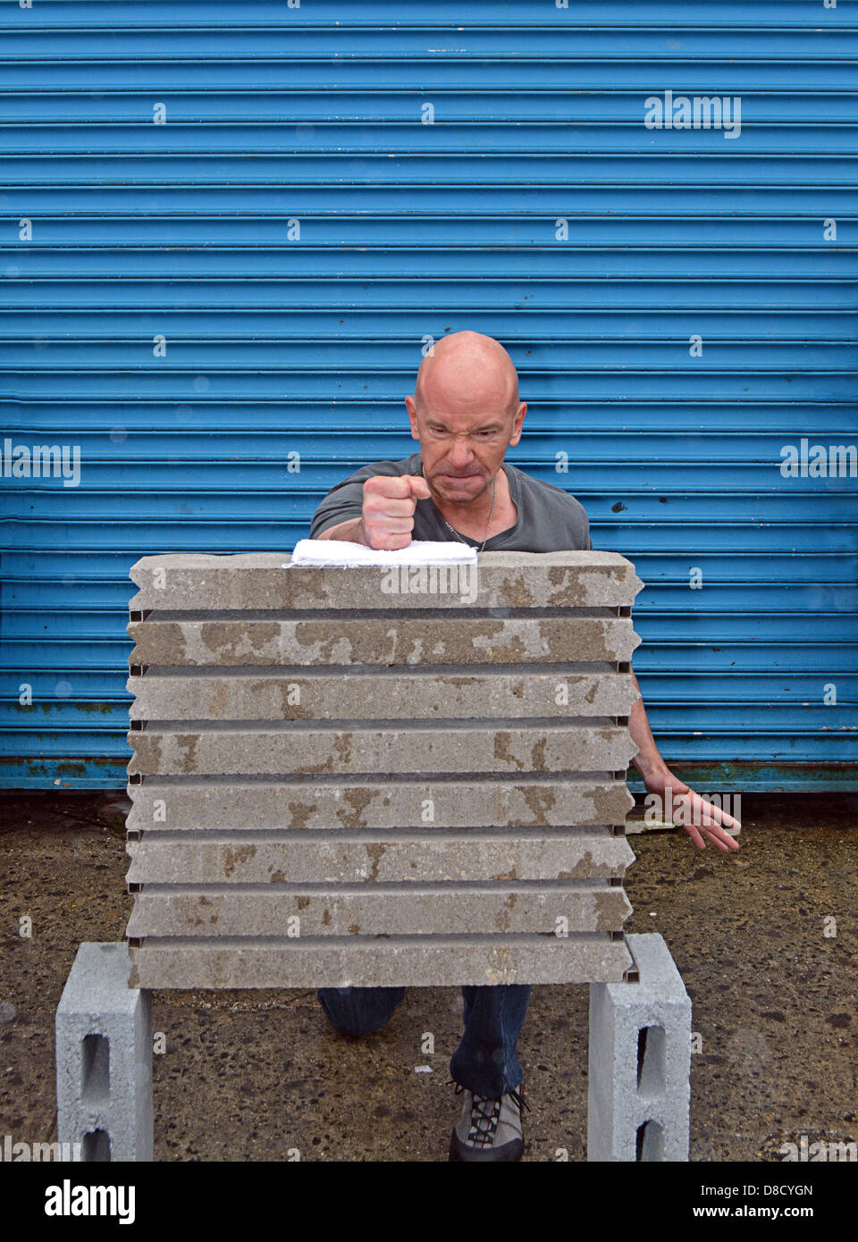 A 51 year old strongman breaks 8 cinder blocks with is bare hands at ...
