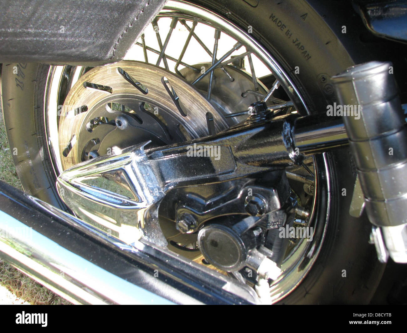 A close-up of a motorcycle wheel, showing intricate details of the tire ...