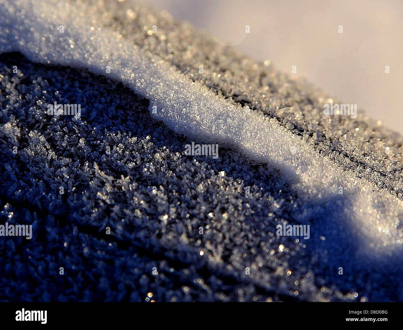 A close-up image of frost and ice crystals forming on a surface during ...