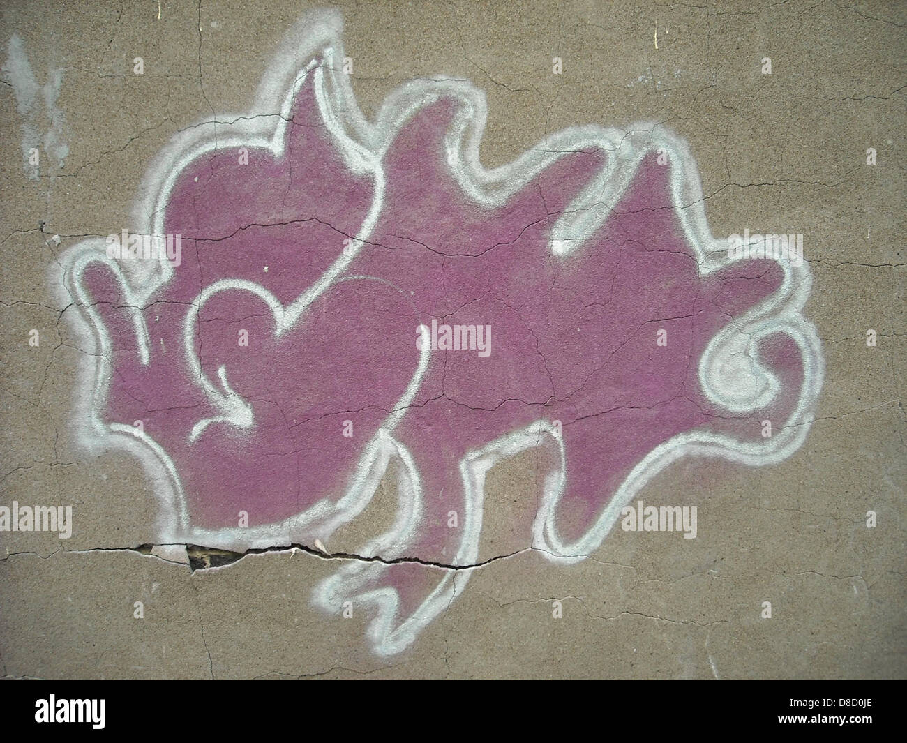 This image shows a pink graffiti design on a wall, featuring bold ...