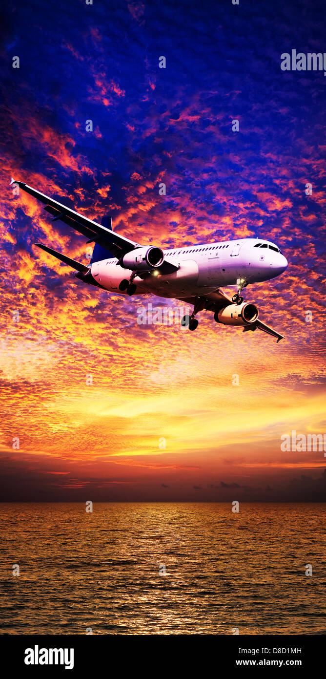 Jet over the sea at sunset time. Vertical shot Stock Photo - Alamy