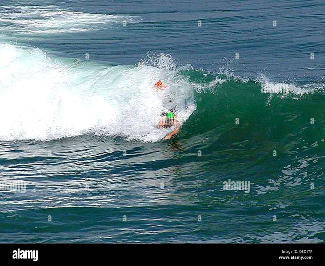 This image shows a person engaged in bodysurfing, riding the waves of ...