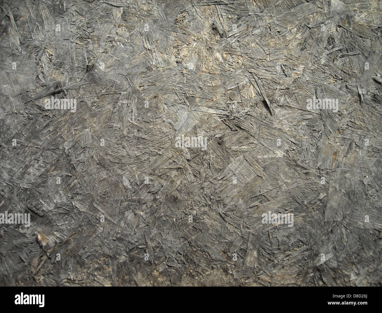 A close-up shot of old chipboard, showing its rough texture and aged ...