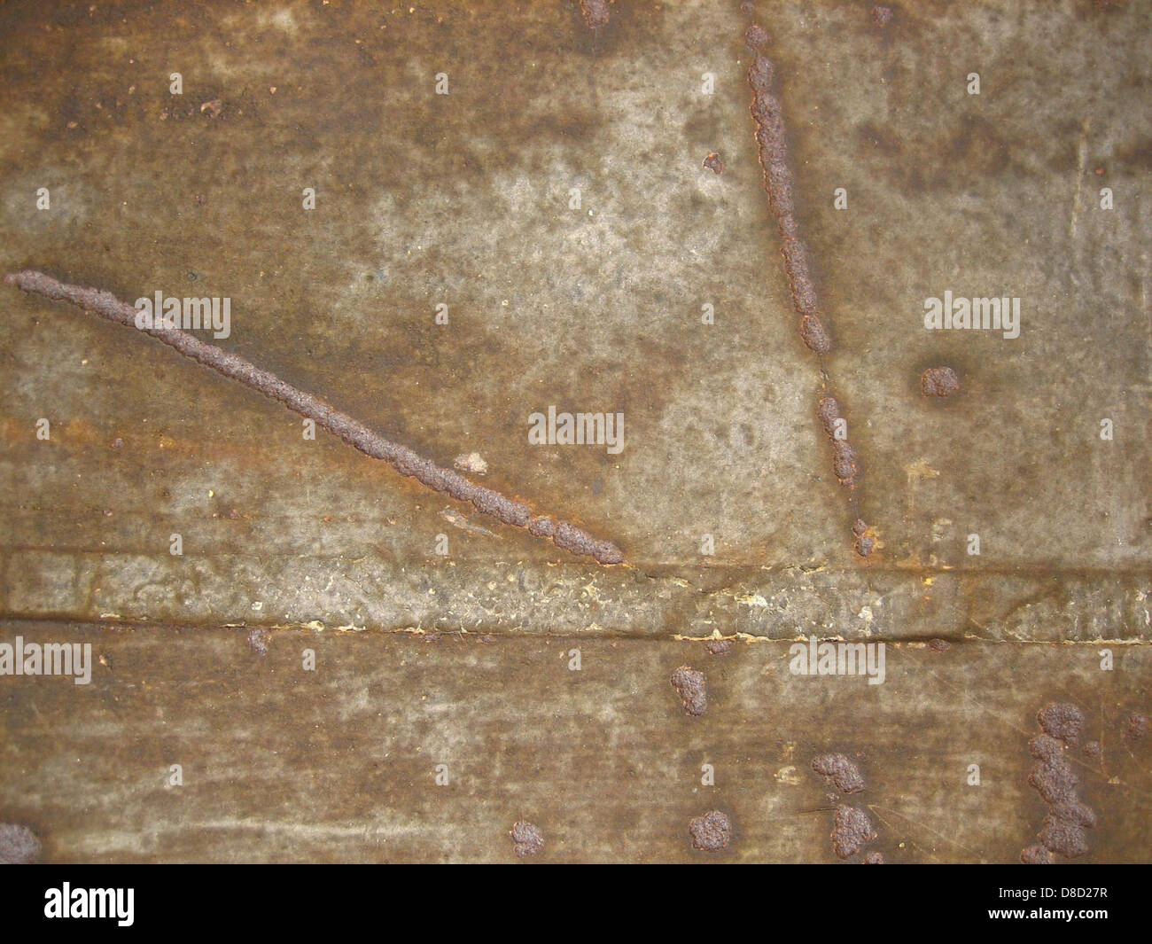 A close-up of an old metal surface, covered in dust, rust, and ...