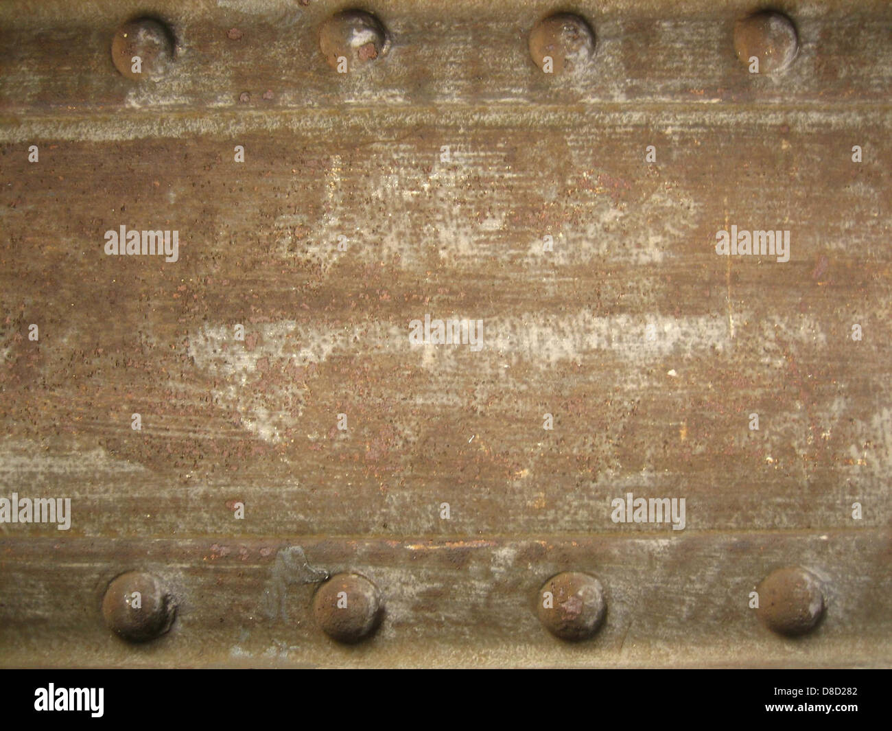 A close-up of an old, weathered iron surface, showing the effects of ...