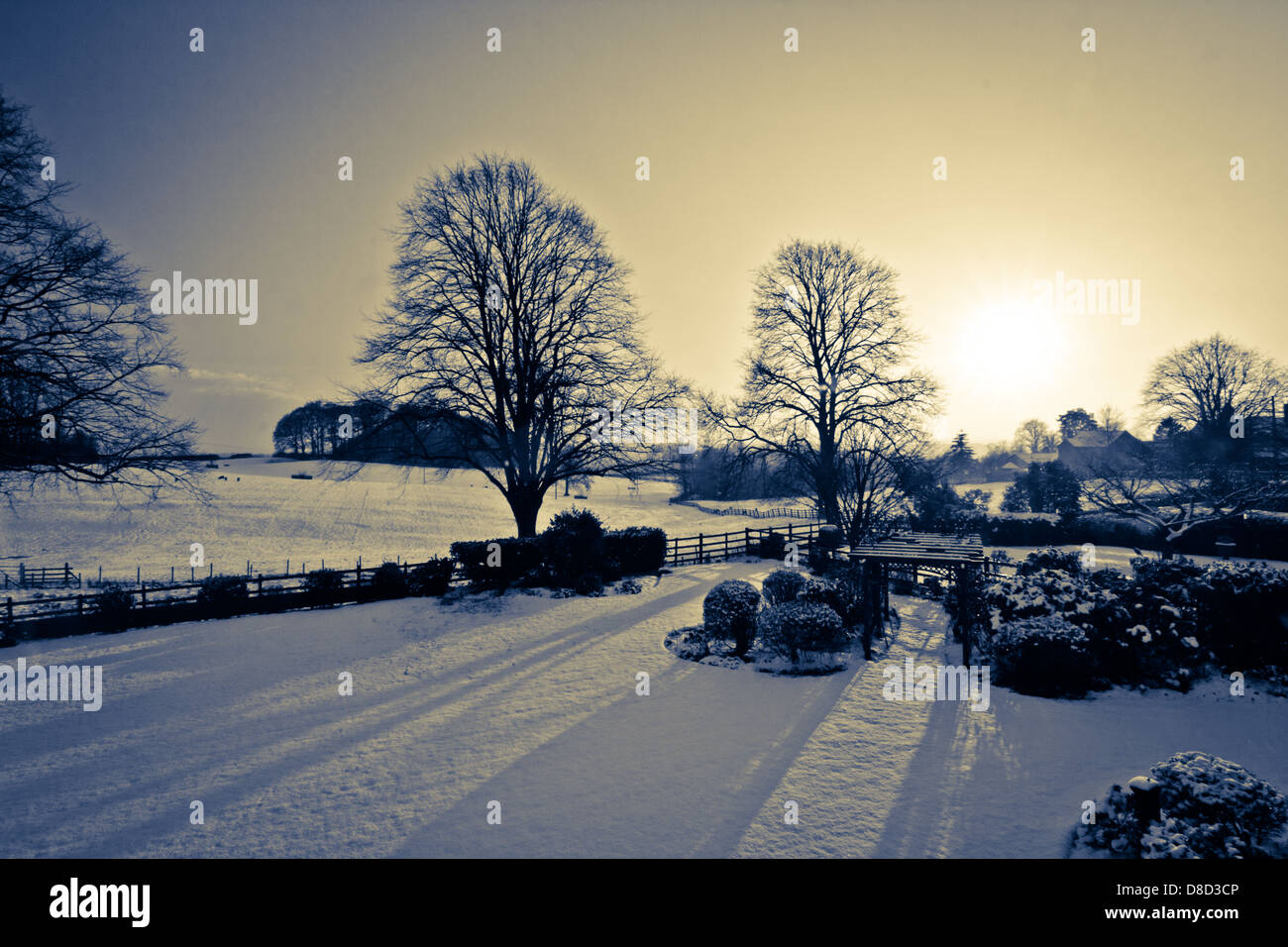 Snowy English countryside with bright Winter Sun over snow covered ...