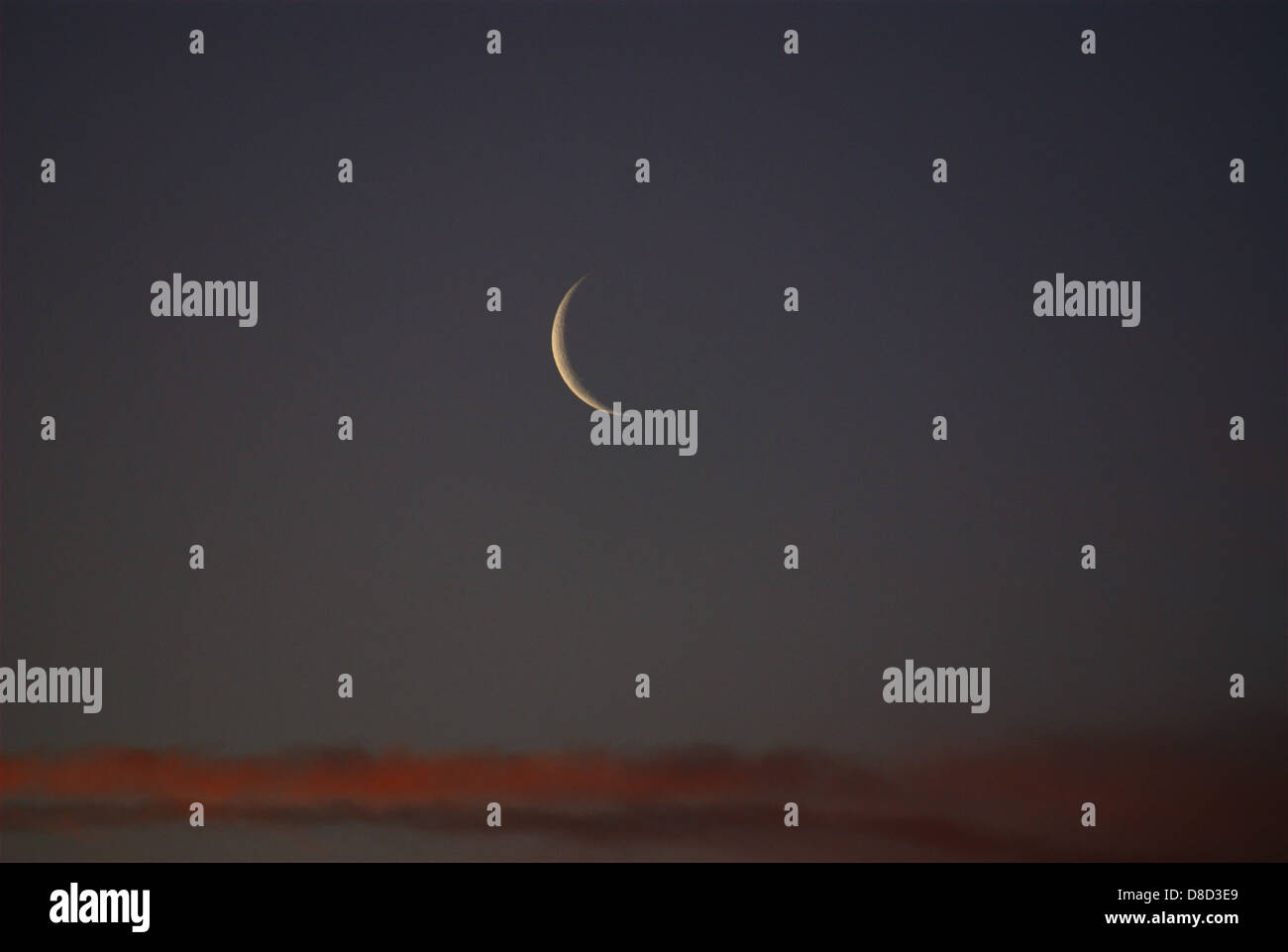 A new moon appears in the sky at sunset, marking the beginning of a ...