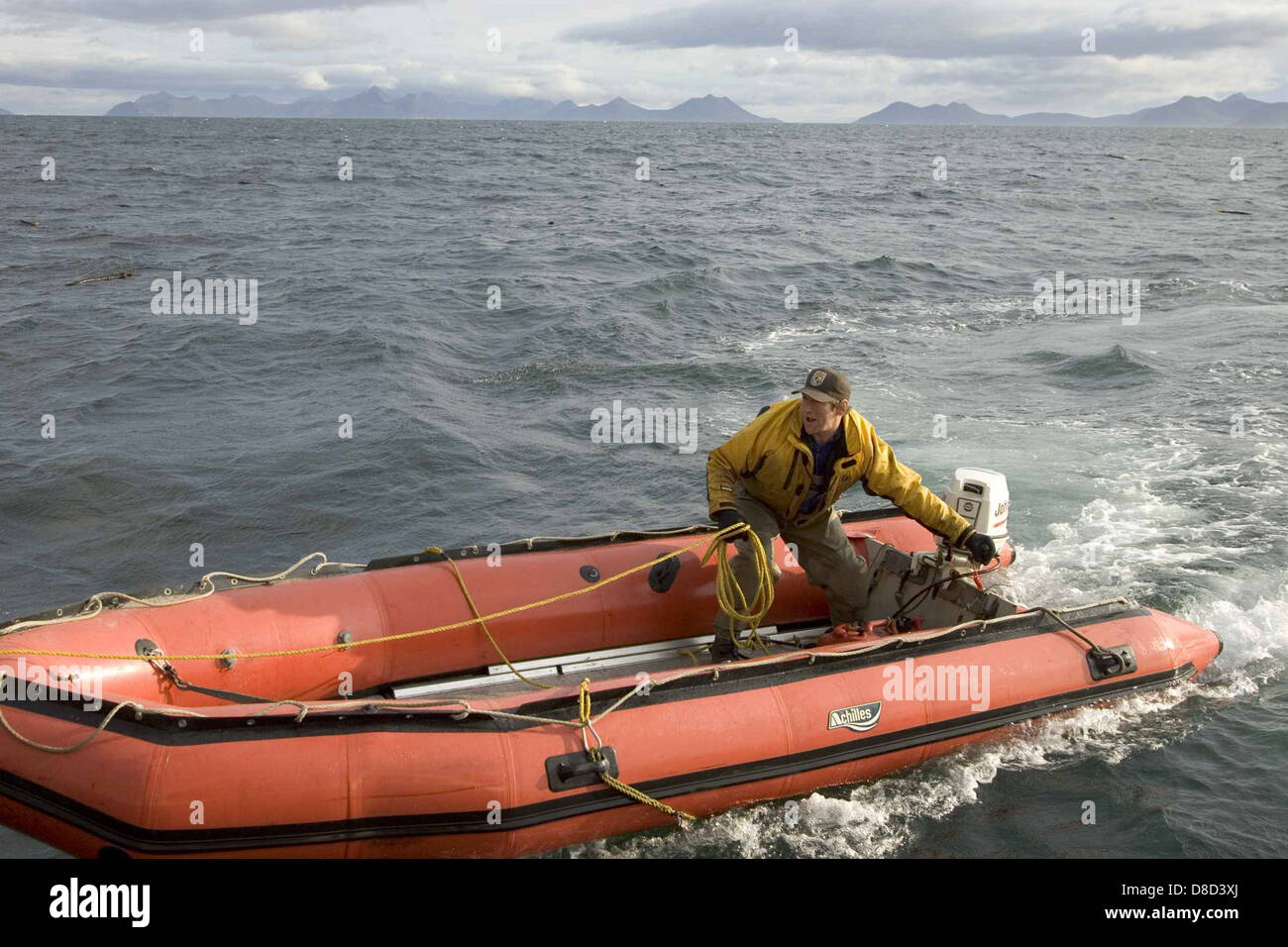 This image shows a person aboard a fast rescue boat, likely responding ...